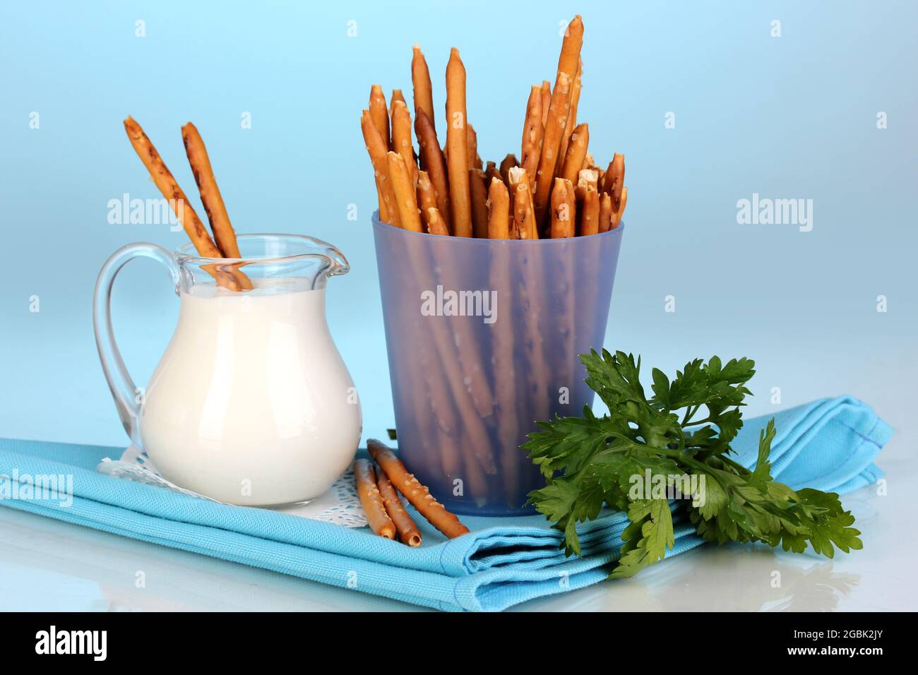 Tasty crispy sticks in purple plastic cup on blue background Stock ...