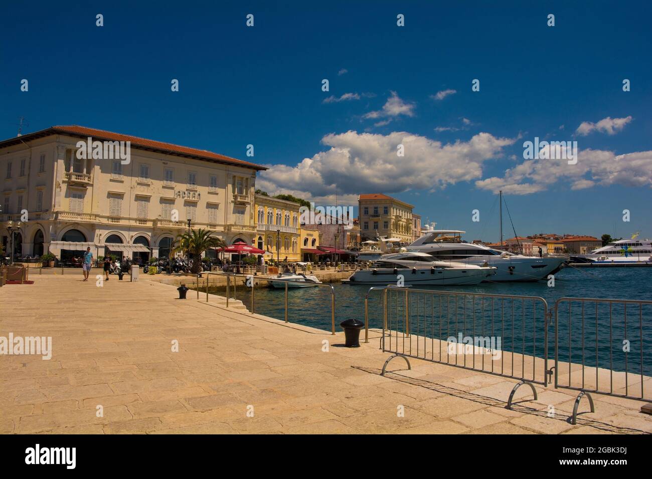 Porec, Croatia- July 10th 2021. A coastal road in the harbour area of ...