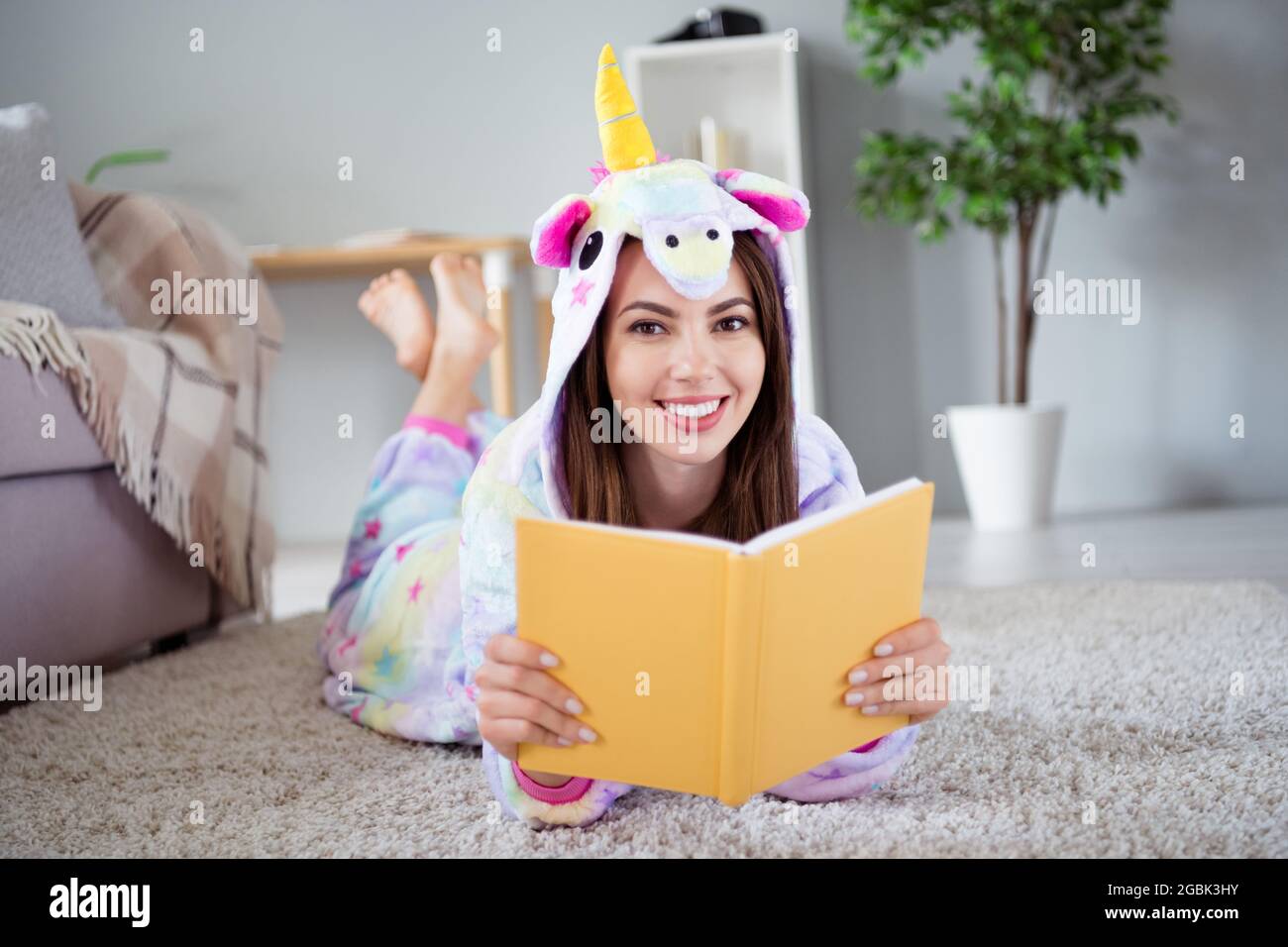 Photo of nice dream positive pretty lady lay floor read interesting ...