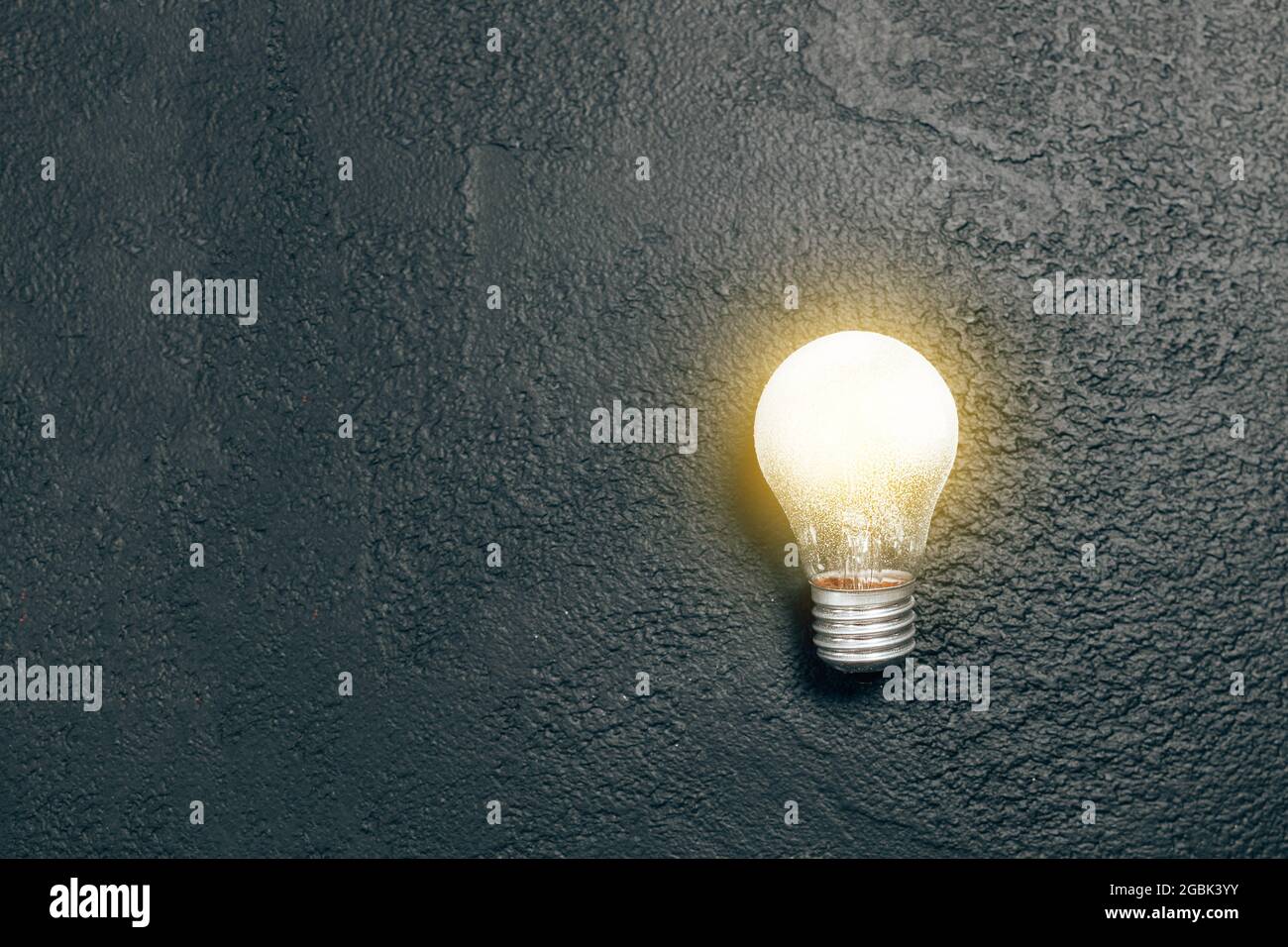 Bright glowing light bulb idea on dark grunge blackboard background ...