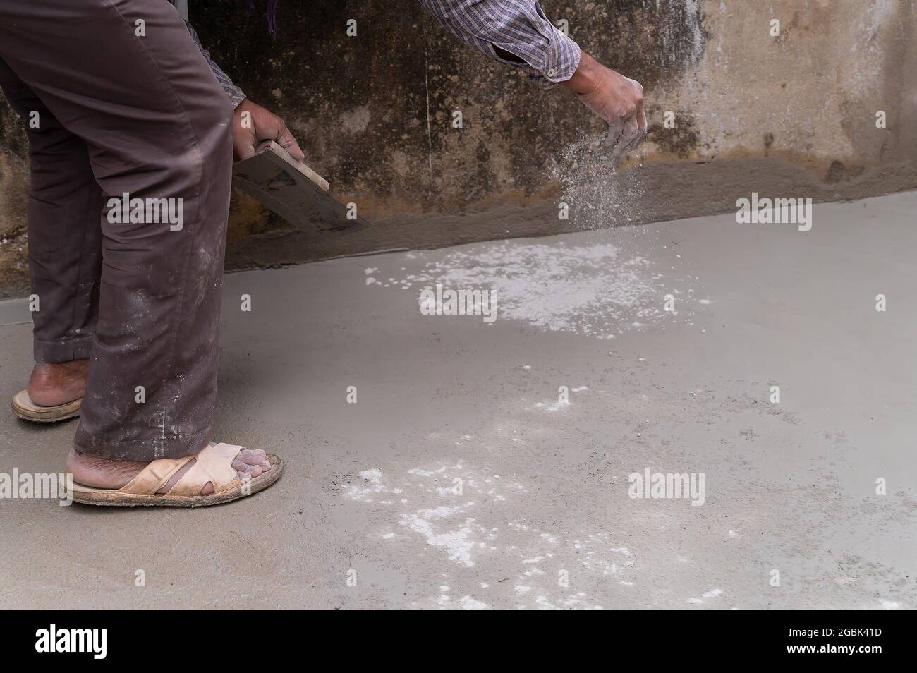 Indian labour levelliing plastered floor using flat trowel and ...