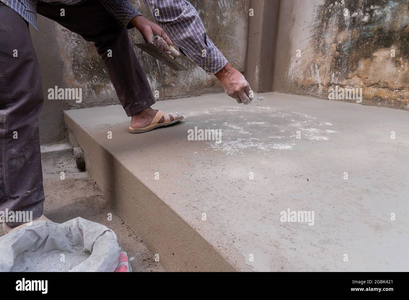 Indian labour levelliing plastered floor using flat trowel and ...