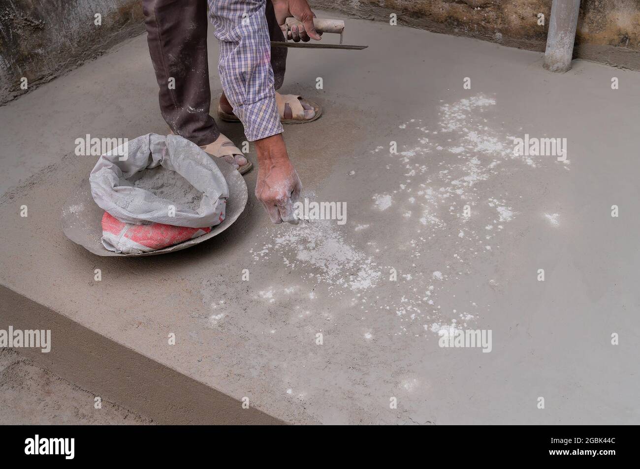Indian labour levelliing plastered floor using flat trowel and ...