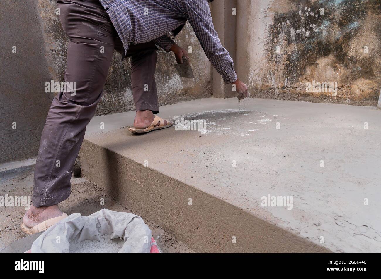 Indian labour levelliing plastered floor using flat trowel and ...