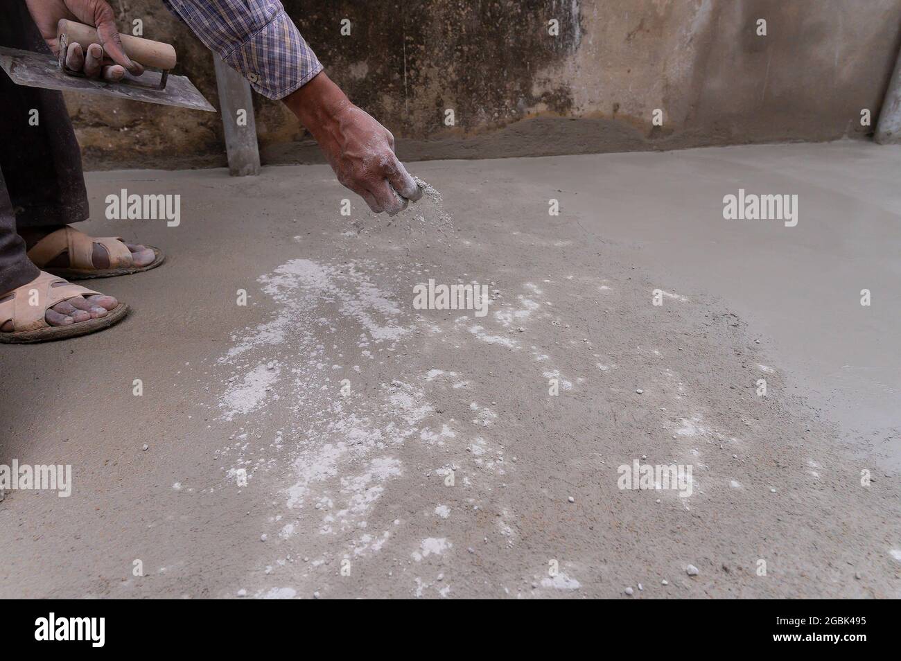 Indian labour levelliing plastered floor using flat trowel and ...