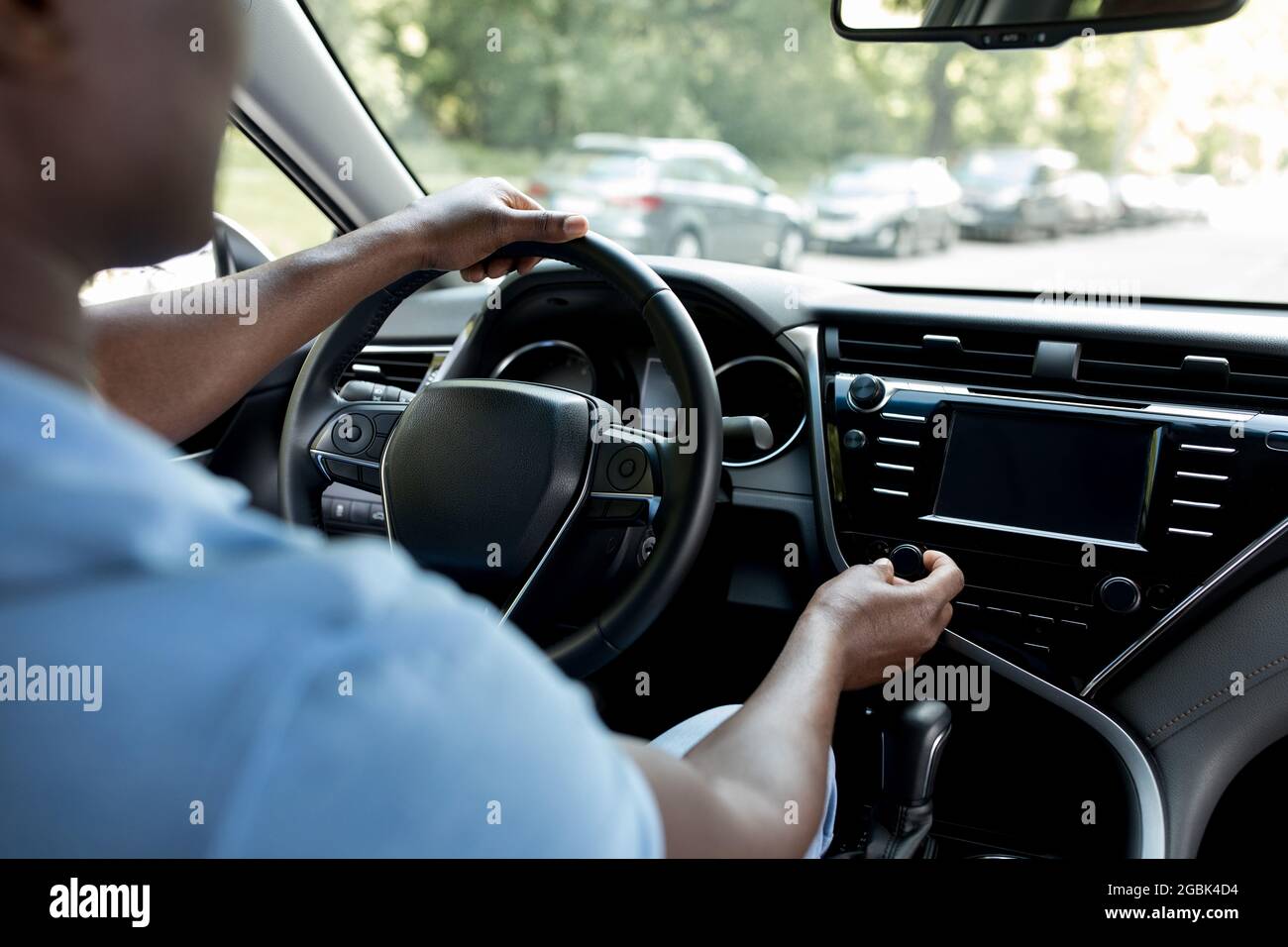 Unrecognizable black man driver turning on radio in auto Stock Photo ...