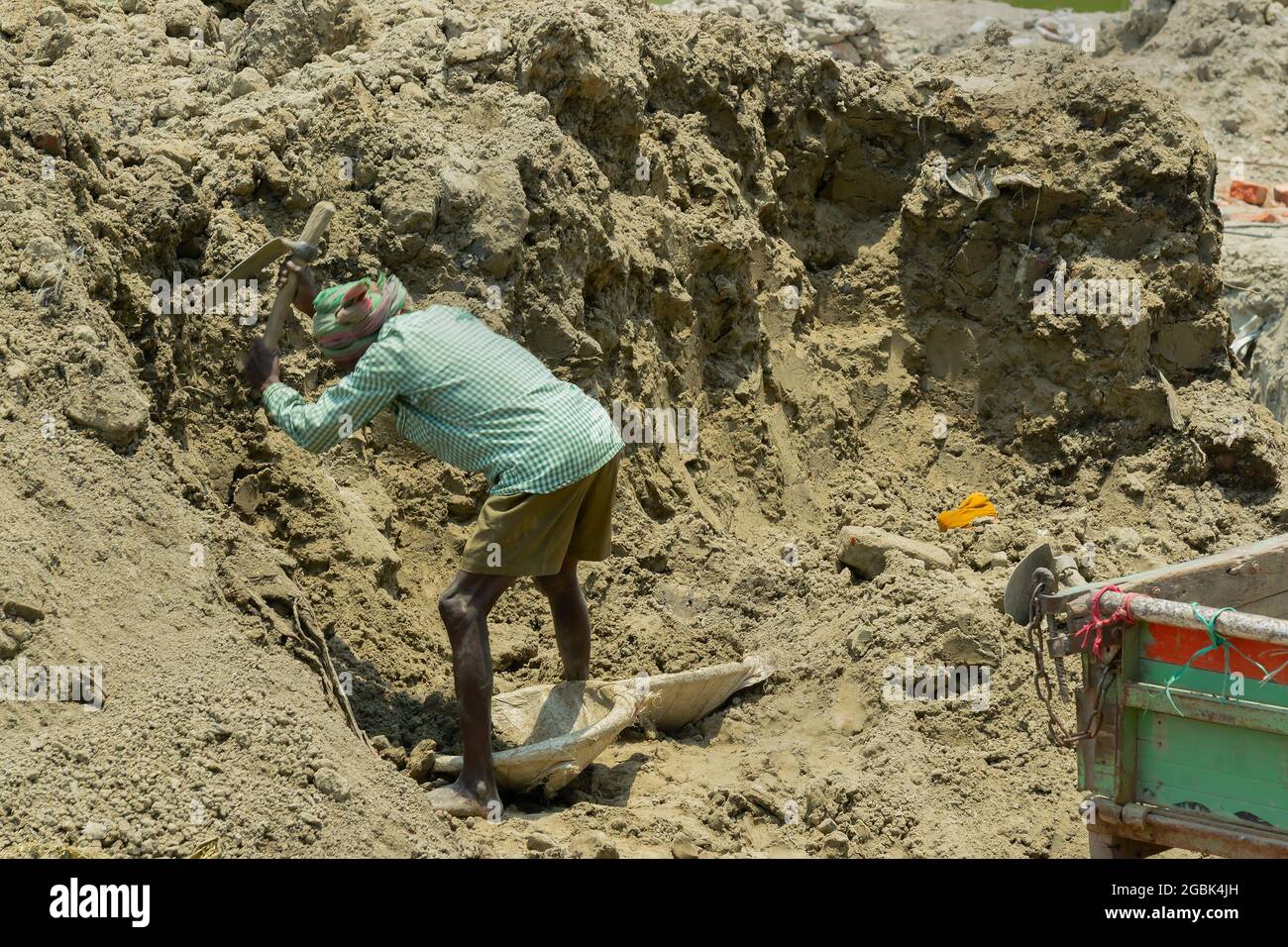 Howrah, West Bengal, India - 7th May 2017 : Indian male worker digging ...