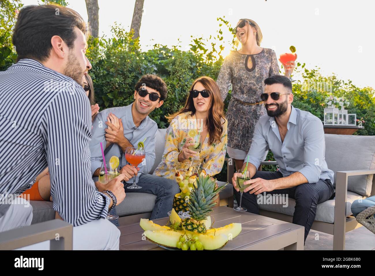 Group of happy young people gathering, talk together and have fun ...