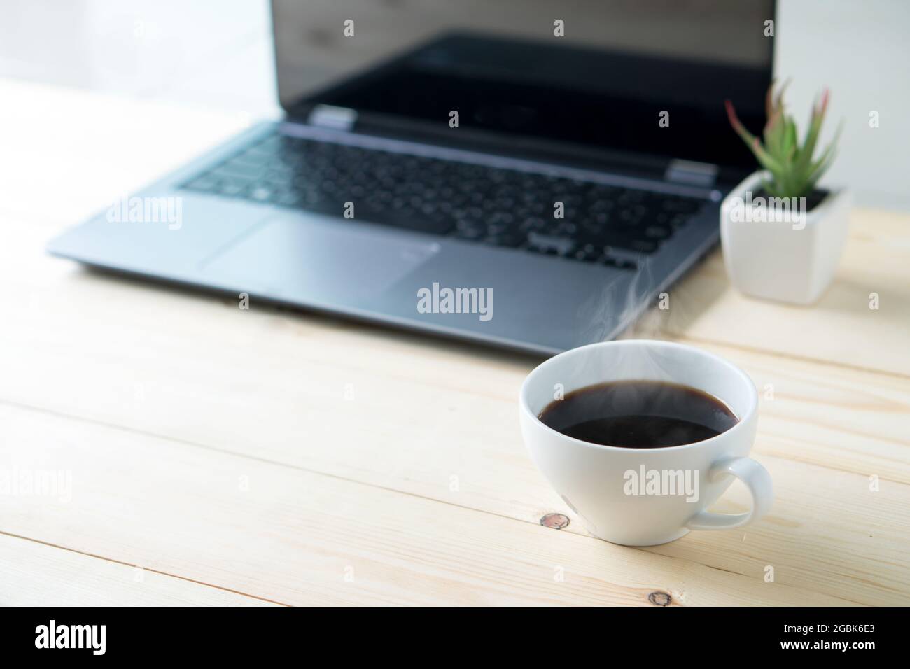 Laptop with blank screen on table interior Stock Photo - Alamy