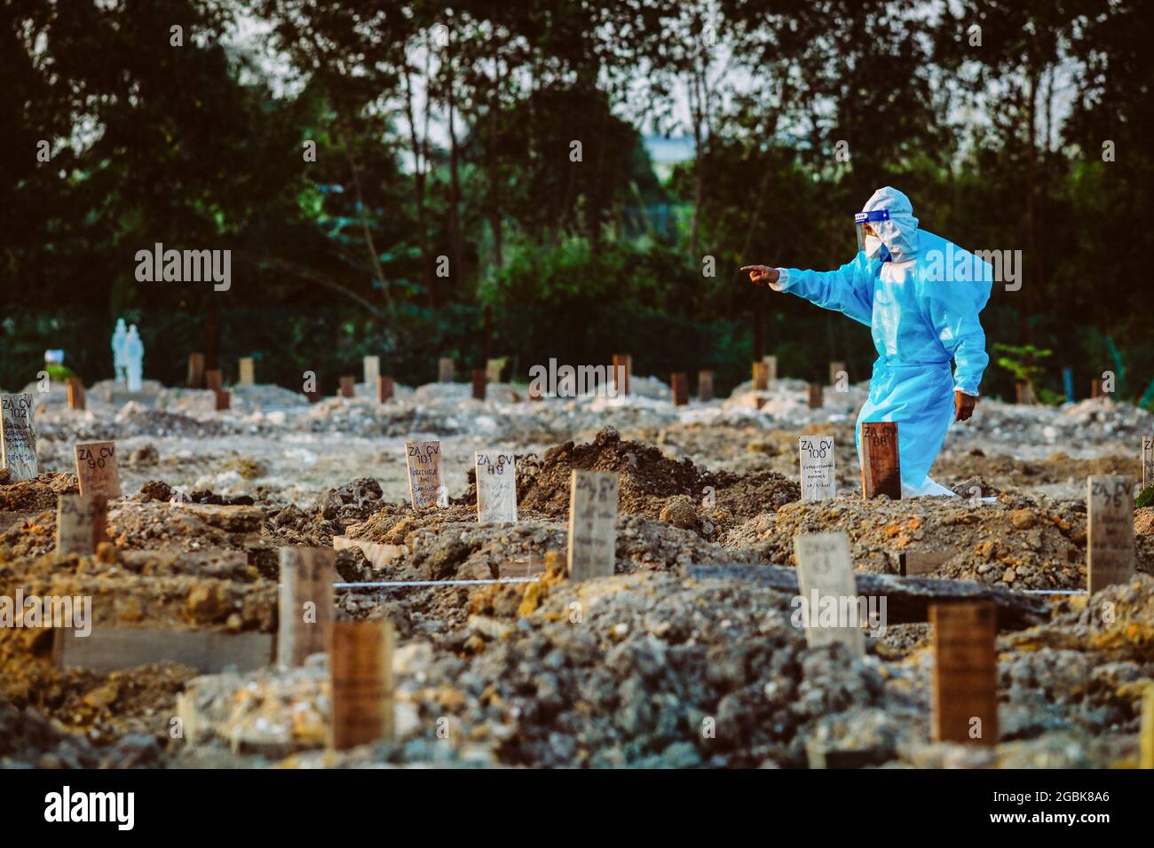 A funeral management worker wearing a Personal Protective Equipment ...