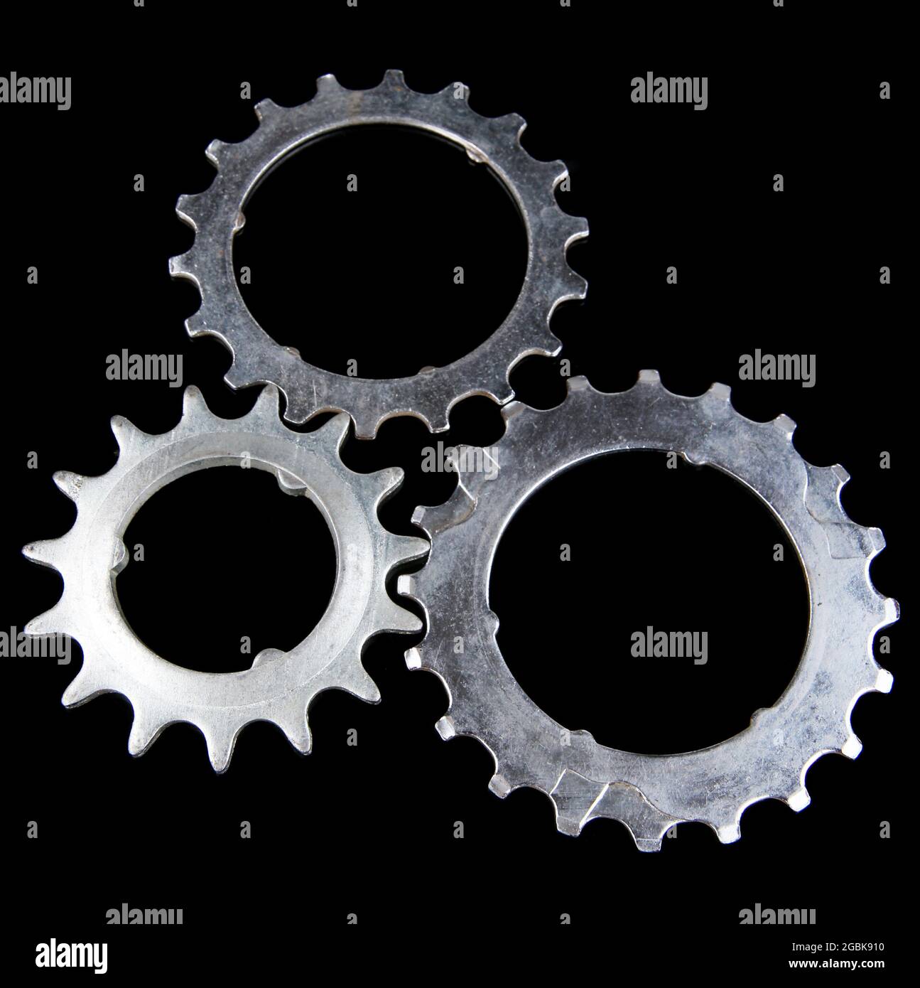 Metal cogwheels on black background Stock Photo - Alamy