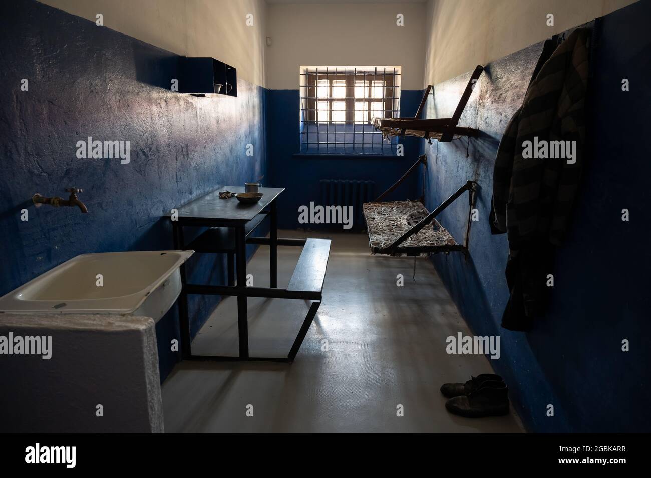 Empty double prison cell with bars on the window Stock Photo - Alamy