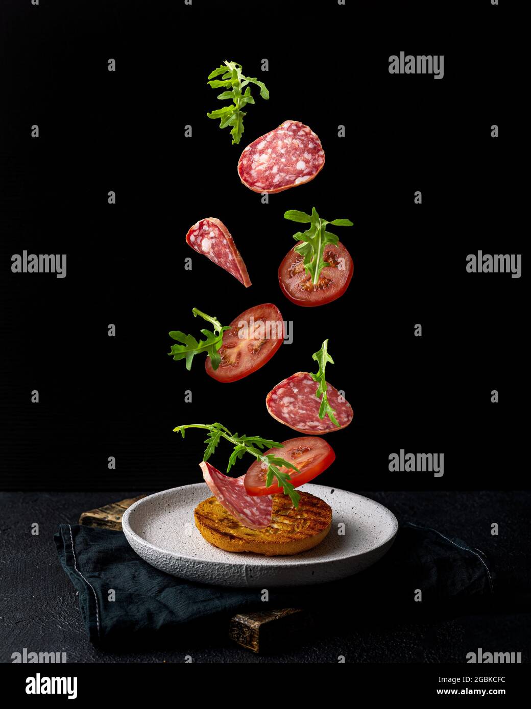 Creative concept with falling food on black backdrop Stock Photo - Alamy