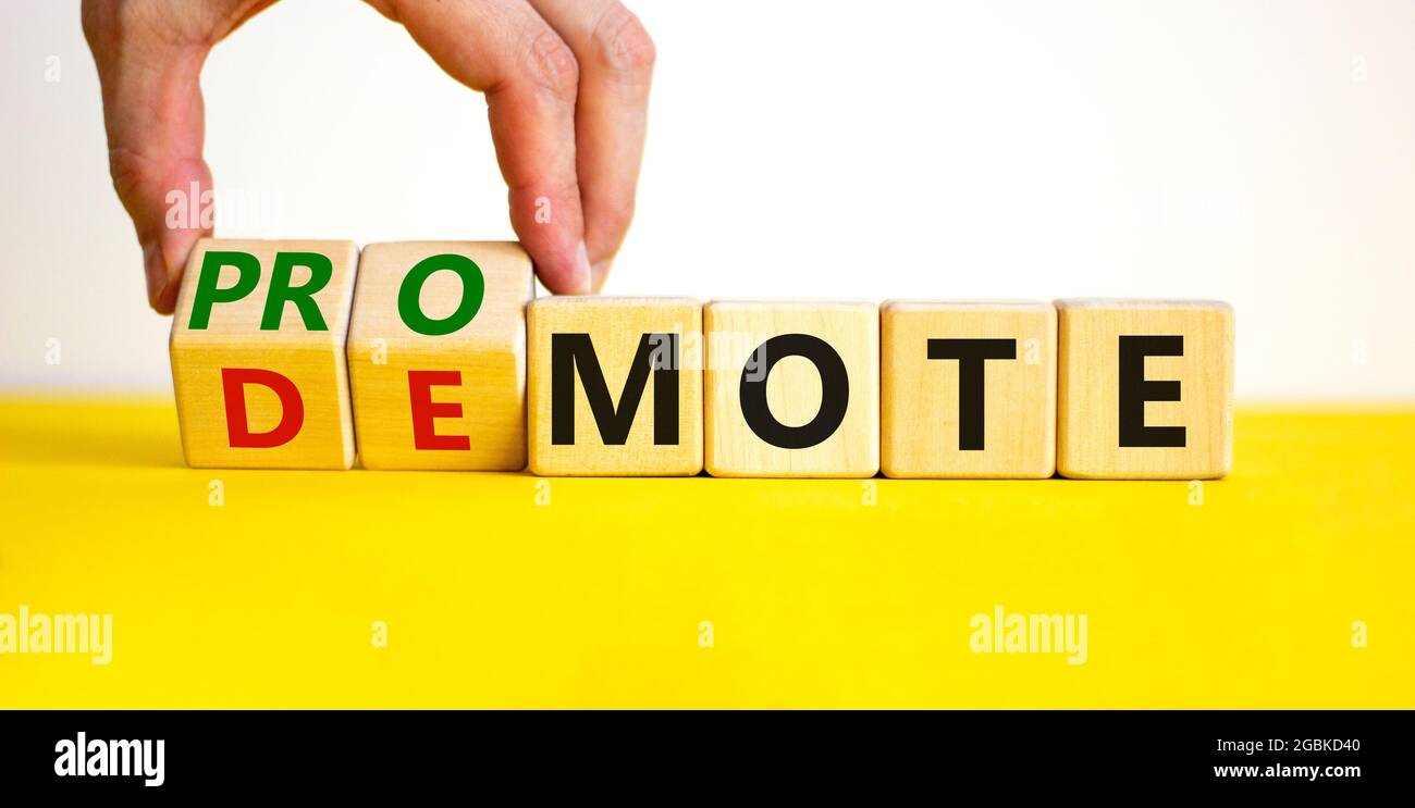 Promote or demote symbol. Businessman turns cubes and changes the word ...
