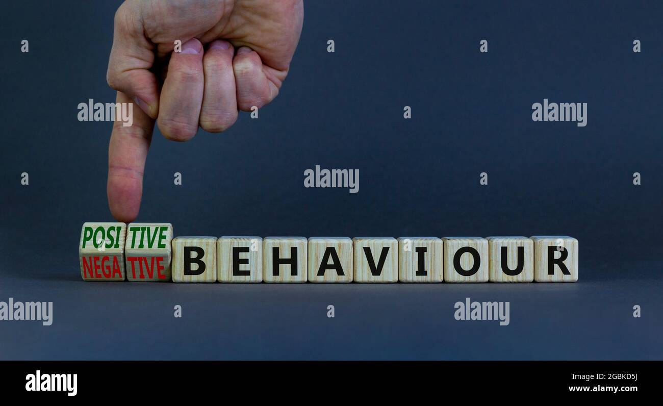 Positive or negative behaviour symbol. Businessman turns cubes, changes ...