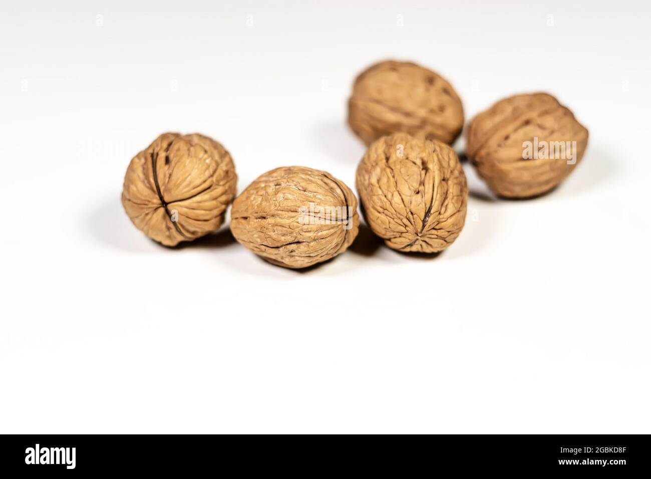 A group of five walnuts isolated on a white background. Healthy ...