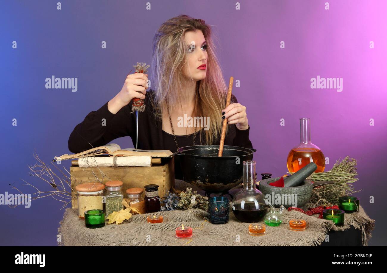 Halloween witch stirring in poison soup in her cauldron on color ...