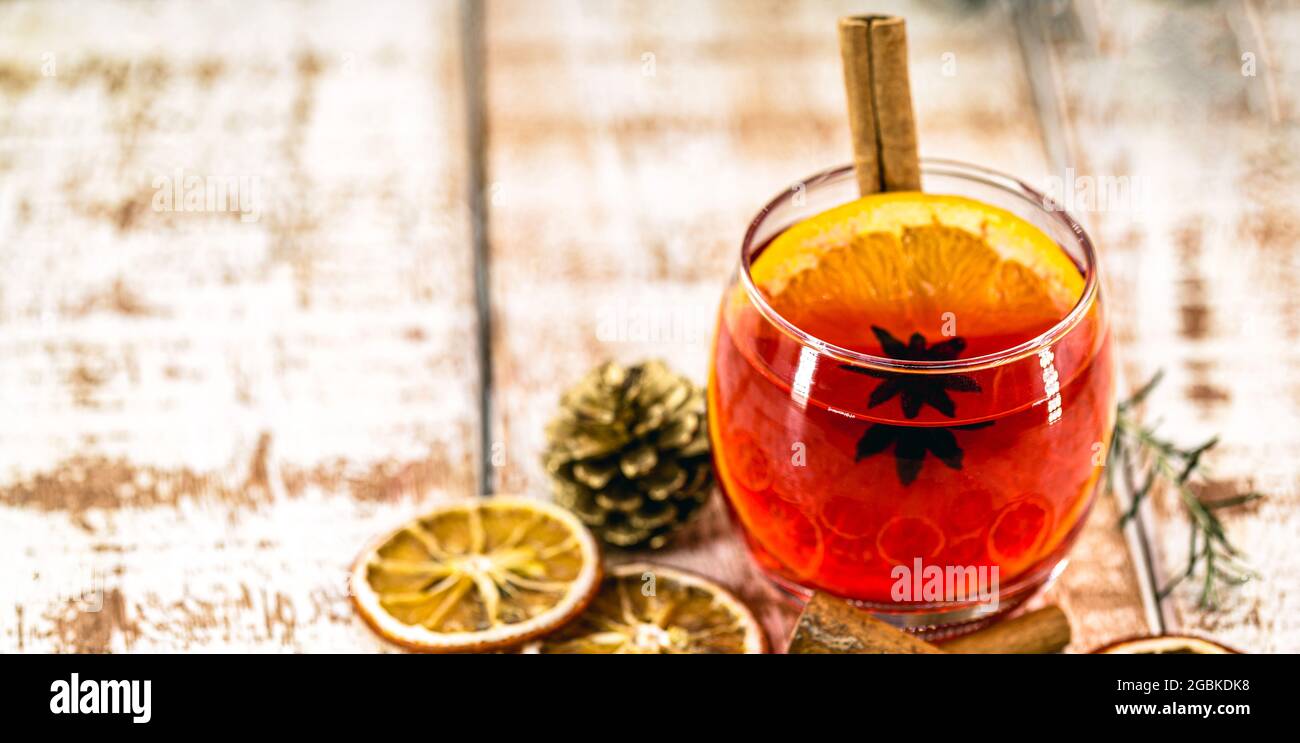 Hot Christmas punch with citrus fruits on a winter table, front view ...