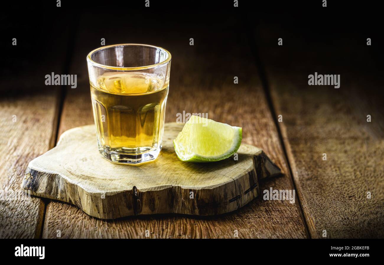 glass of alcoholic drink with lemon, distilled from sugar cane, called ...