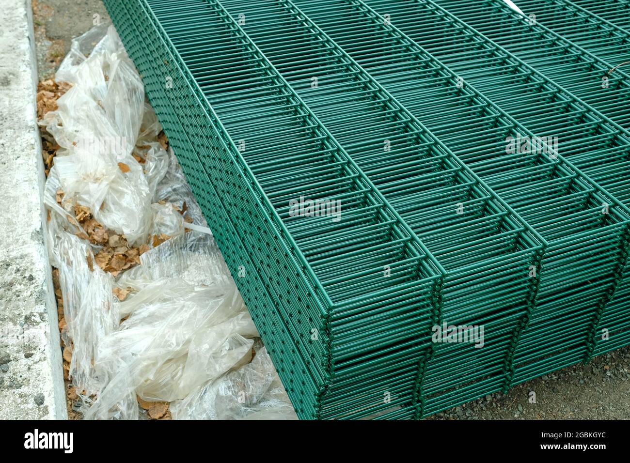Metal products green rods pulled out of packaging Stock Photo - Alamy