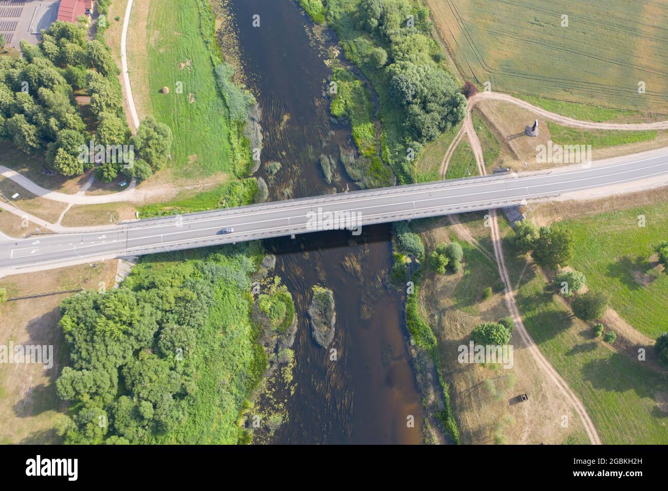 Aerial high angle view of car driving over bridge. River flowing under ...