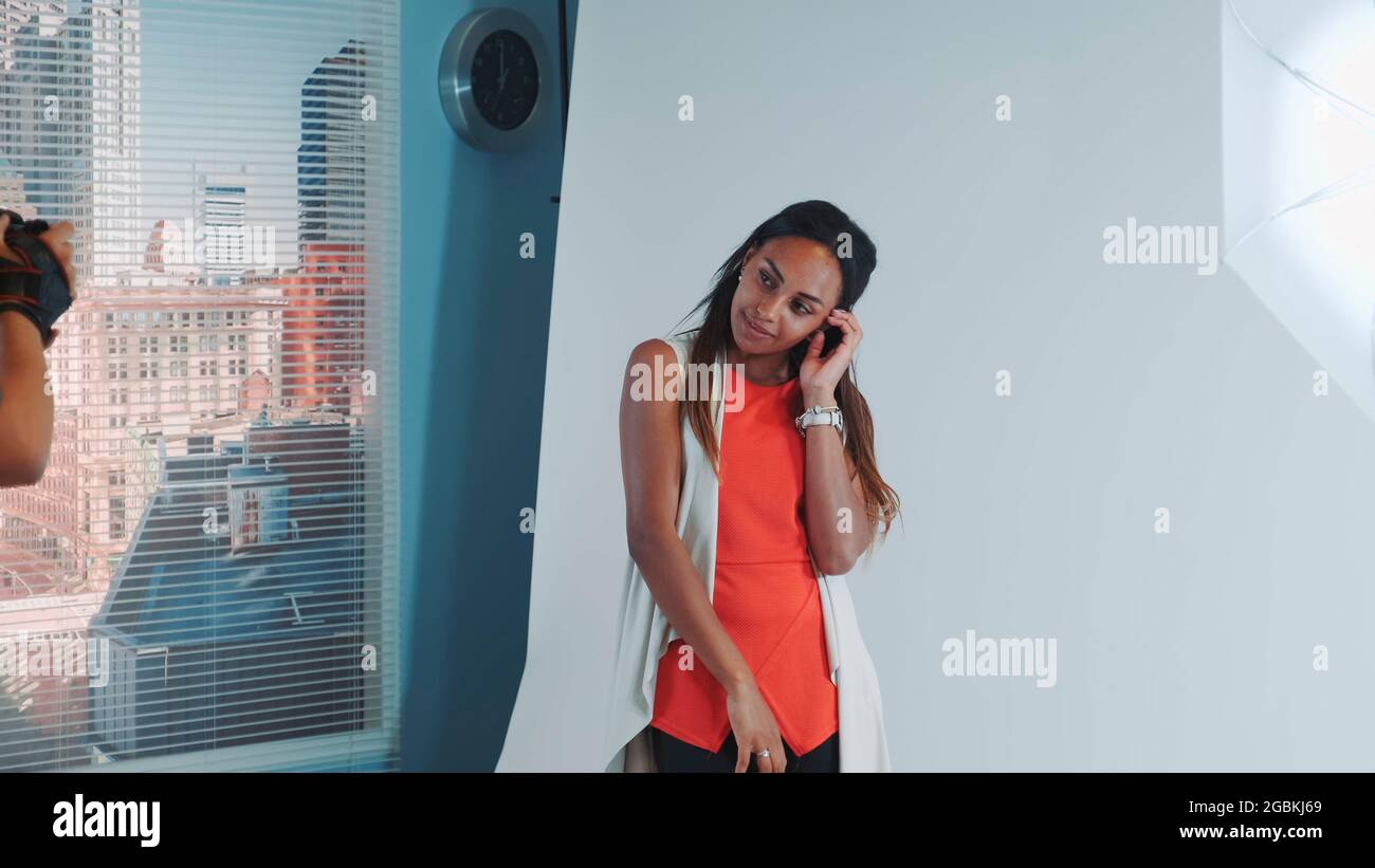 Attractive fashion model of african ethnicity posing for a photographer ...