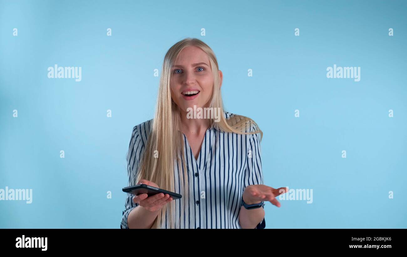 Attractive young woman is very delighted with something looking on ...