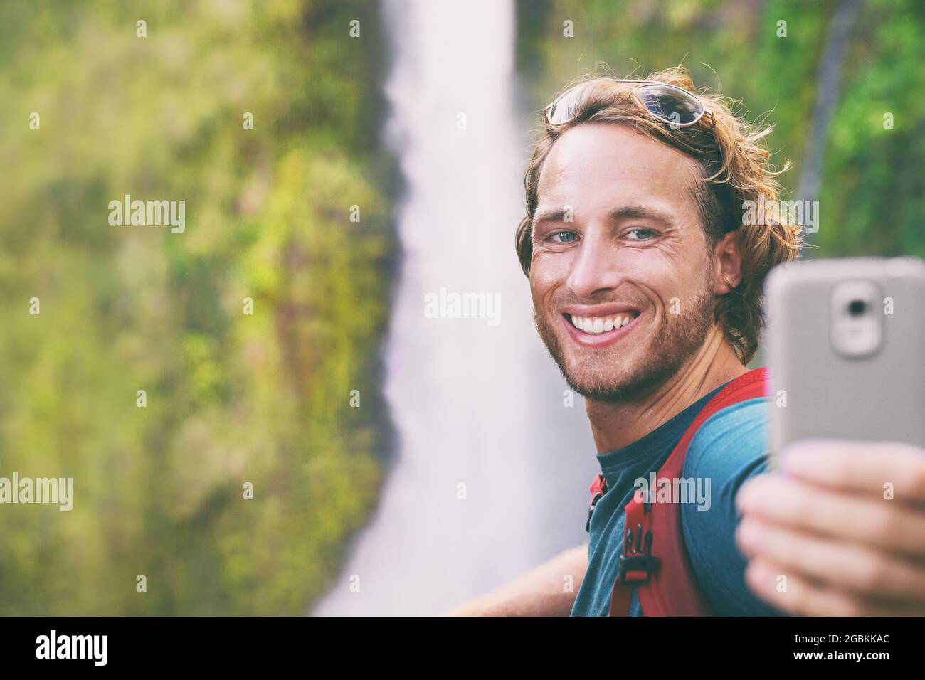 Selfie travel tourist man taking photo with phone on adventure hike ...