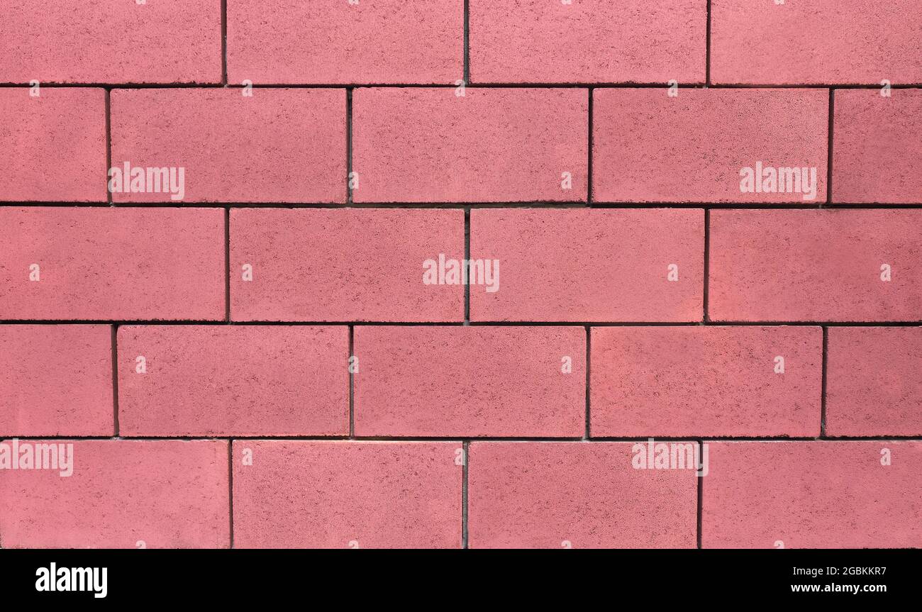 Wall of concrete blocks in pink, background Stock Photo - Alamy