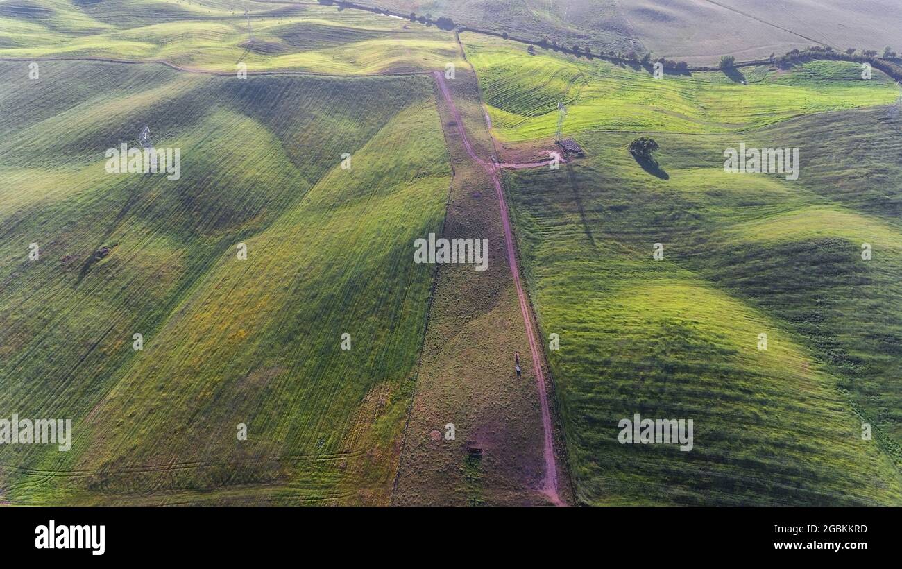 Aerial footage of the pasture. Green hills and roads. Nature Stock ...