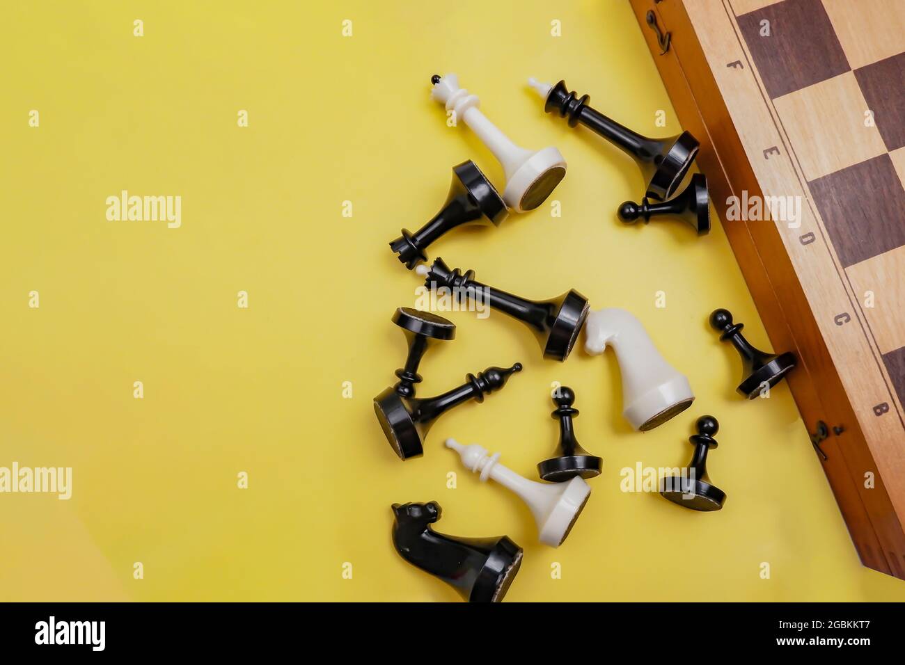 chess pieces are scattered on a yellow background next to the ...