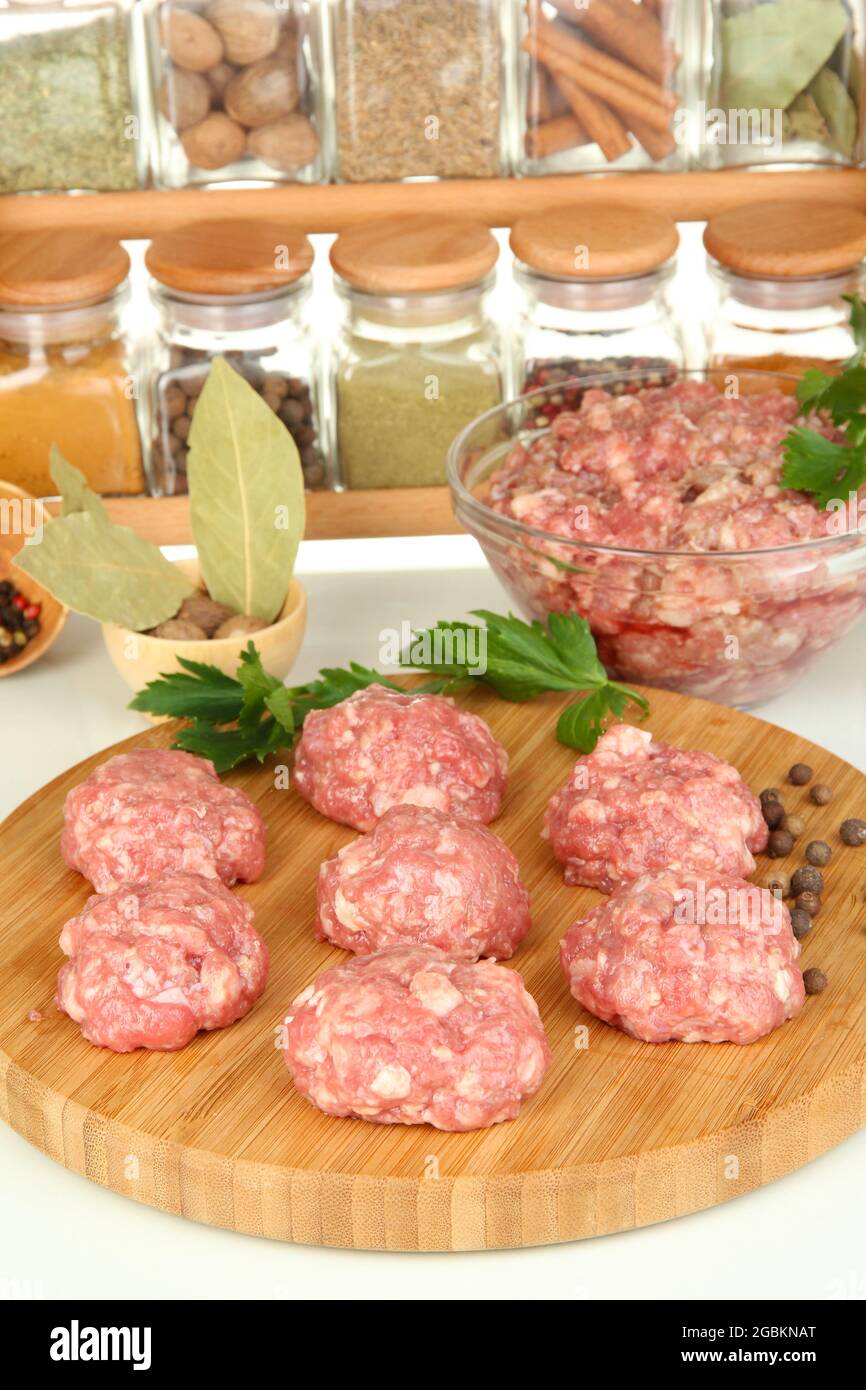 Raw meatballs with spices Stock Photo - Alamy