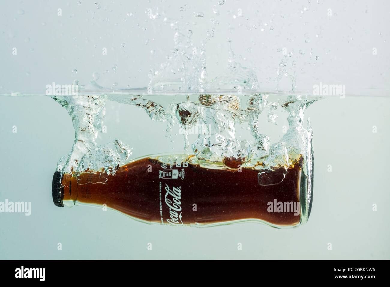 Close up view of Coca cola bottle falling in water Stock Photo - Alamy