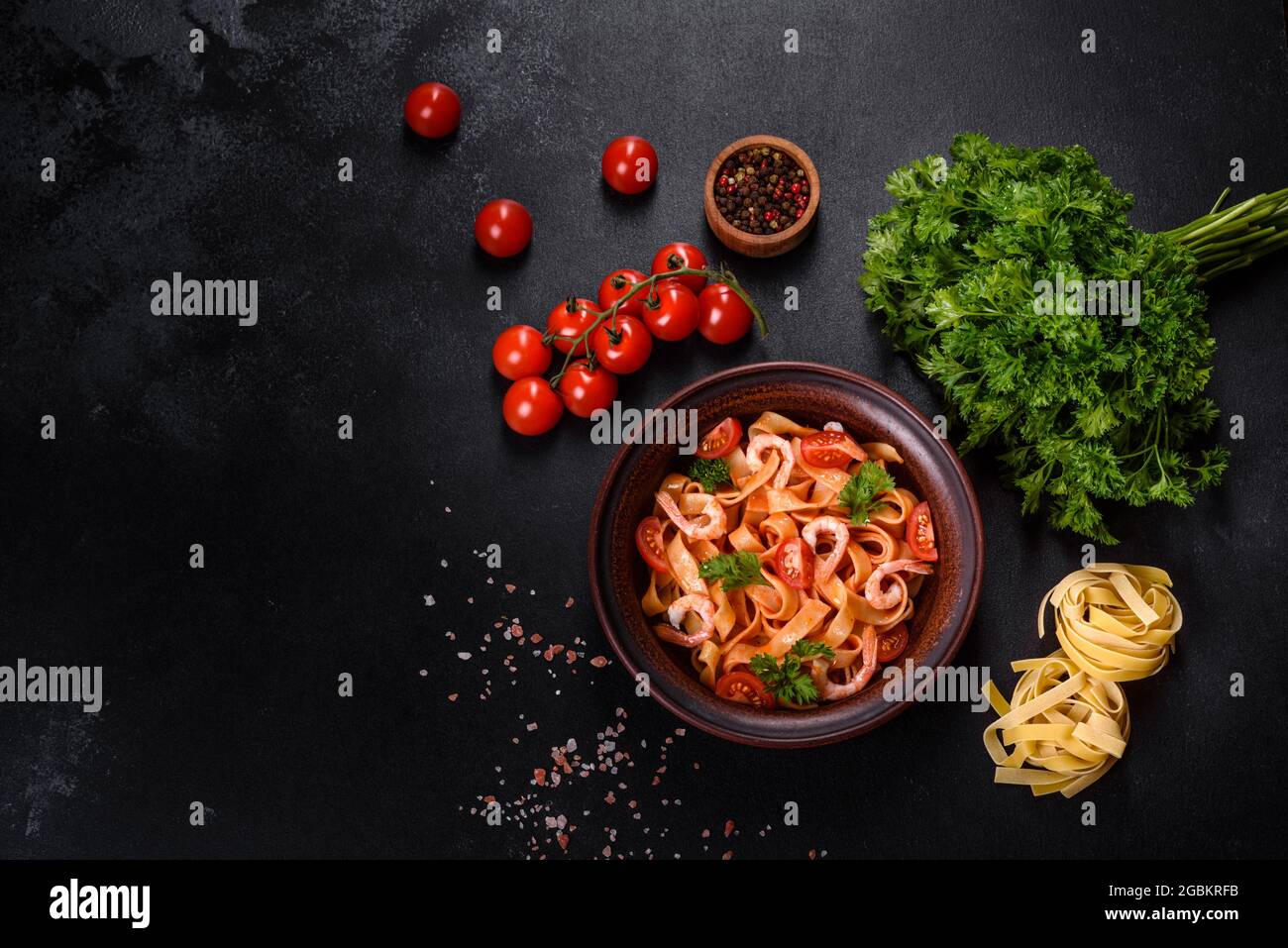 Fettuccine pasta with shrimp, cherry tomatoes, sauce, spices and herbs ...