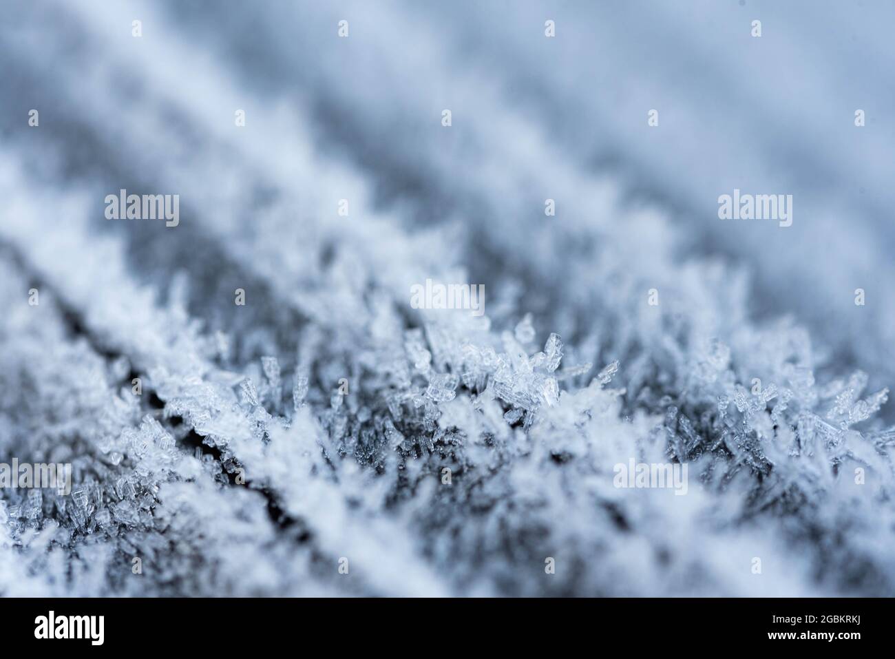 Frost on the roof, corrugated sheet covered with white ice crystals ...