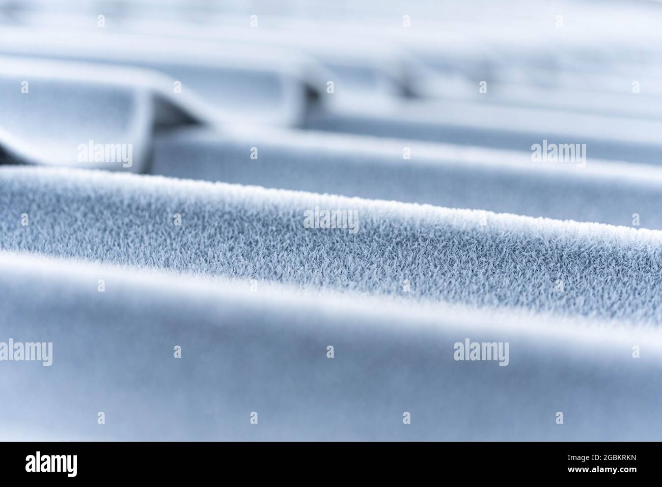 Frost on the roof, corrugated sheet covered with white ice crystals ...