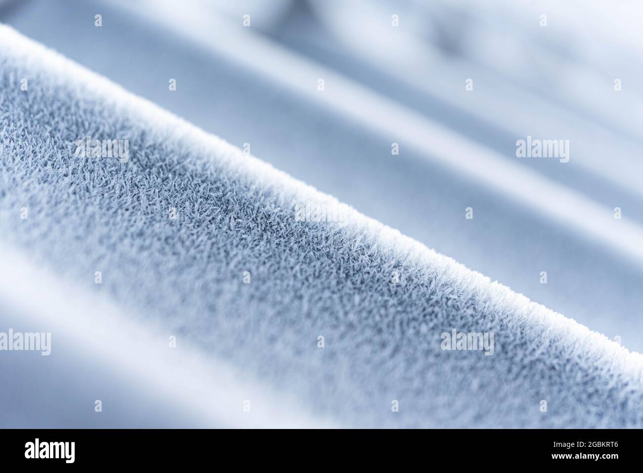 Frost on the roof, corrugated sheet covered with white ice crystals ...