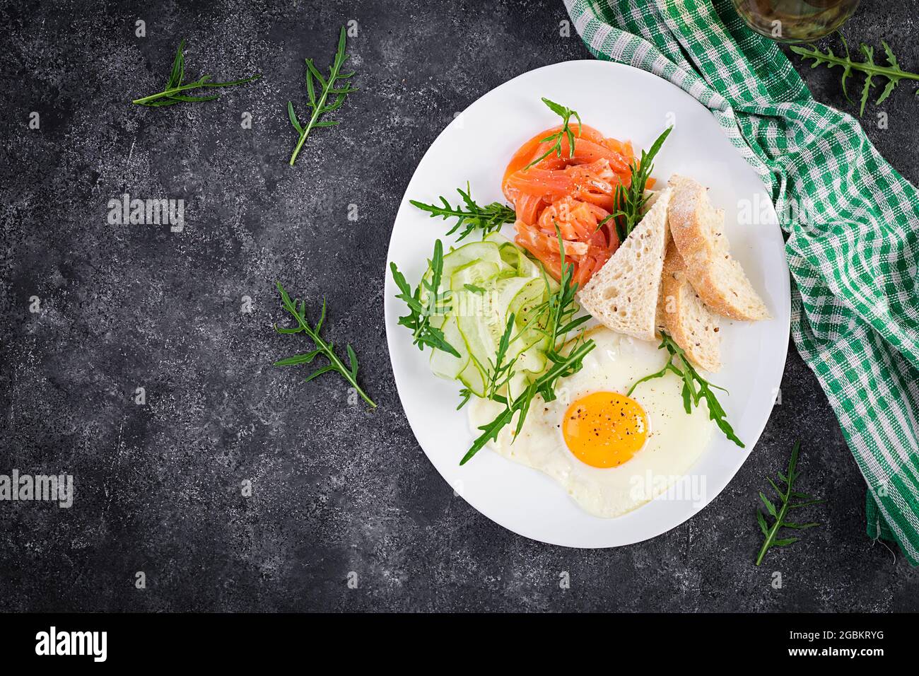 Diet breakfast. Salt salmon salad with greens, cucumbers, fried egg and ...
