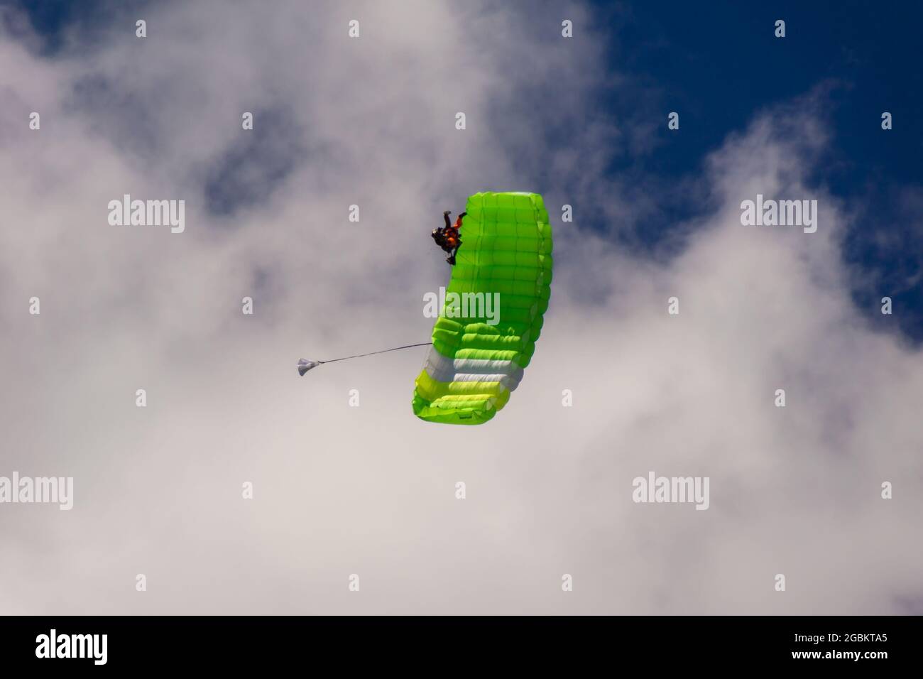 green parachute against the background of blue sky and clouds Stock ...
