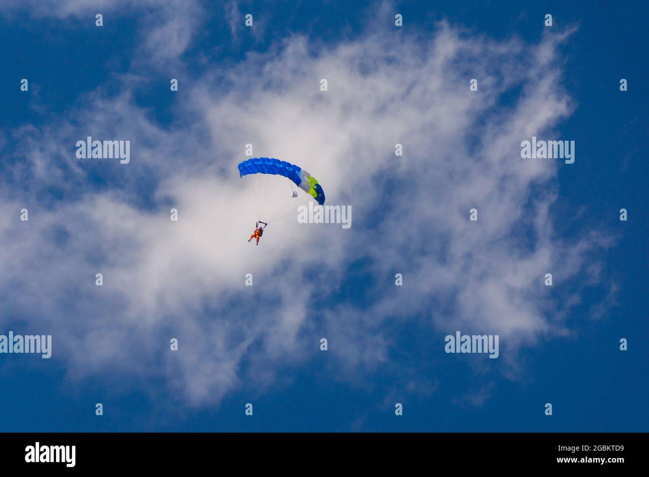 blue parachute against the background of blue sky and clouds Stock ...