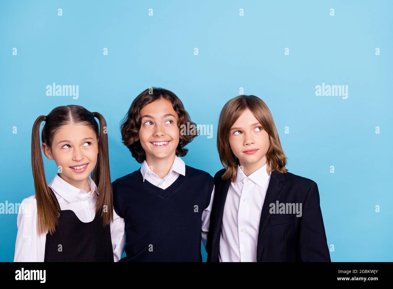 Photo portrait school mates smiling in uniform looking blank space ...