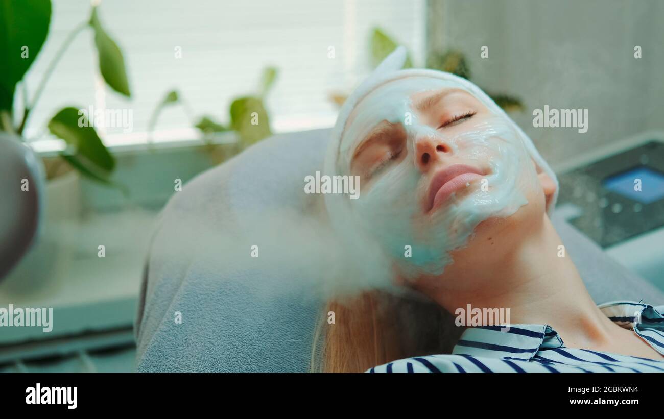 Medium close-up shot of professional facial skin care treatment with a ...