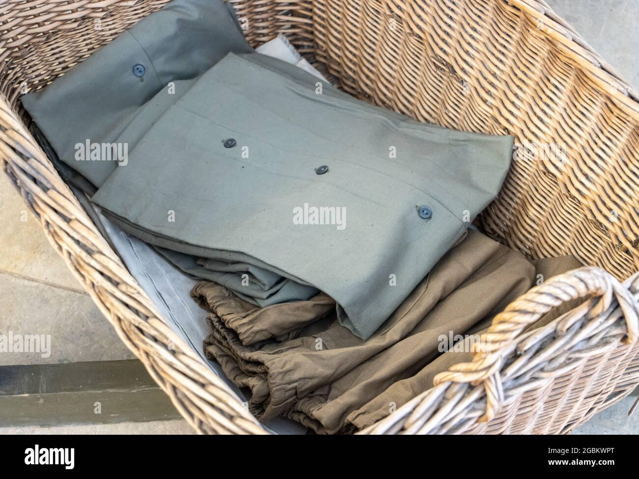 A clean shirts and pants in a wicker basket Stock Photo - Alamy
