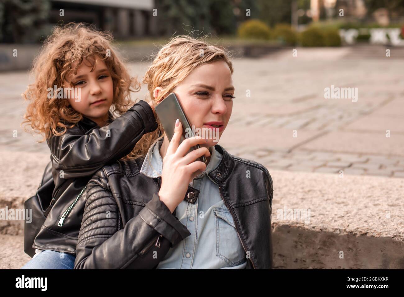 The busy mom with daughter while are walking Stock Photo - Alamy