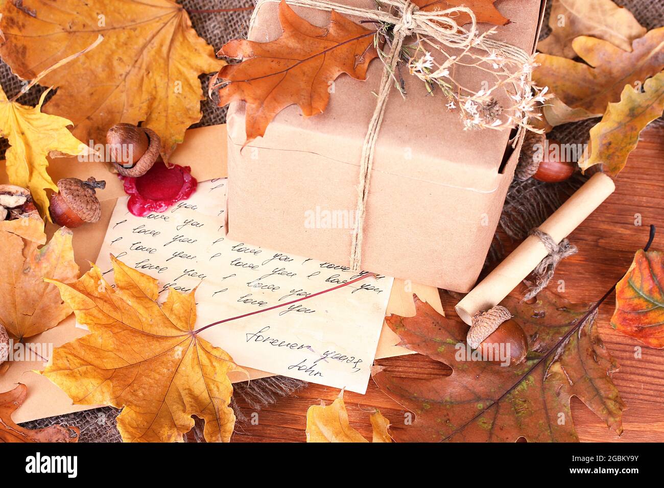 autumn background: vintage gift, letter and leaves Stock Photo - Alamy