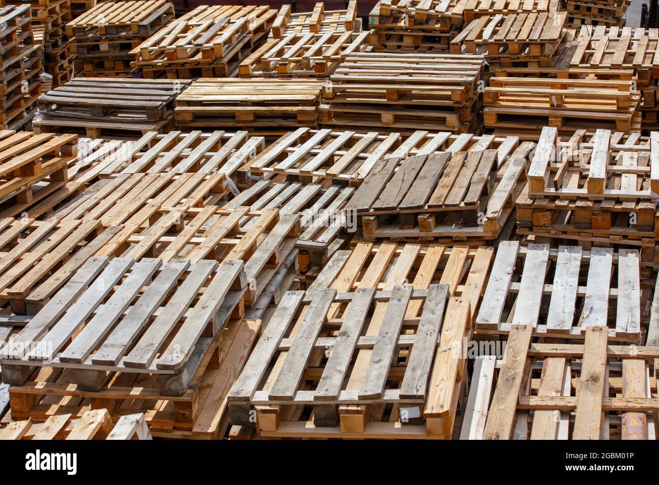 full frame background of used wooden pallet stacks - perspective view ...