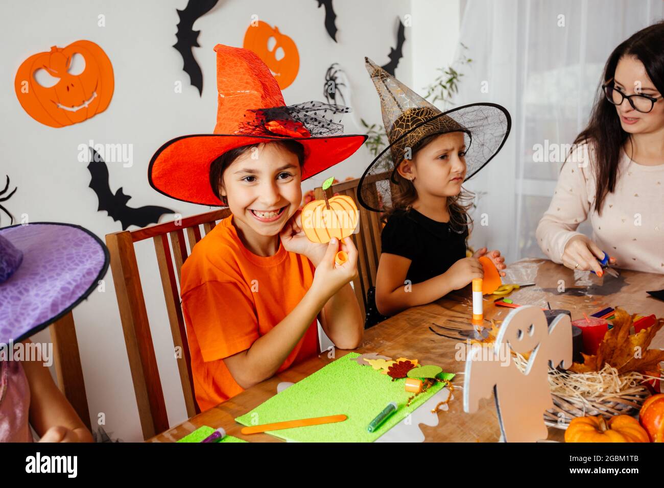 Primary school kids with smiling teacher children learning at school hi ...