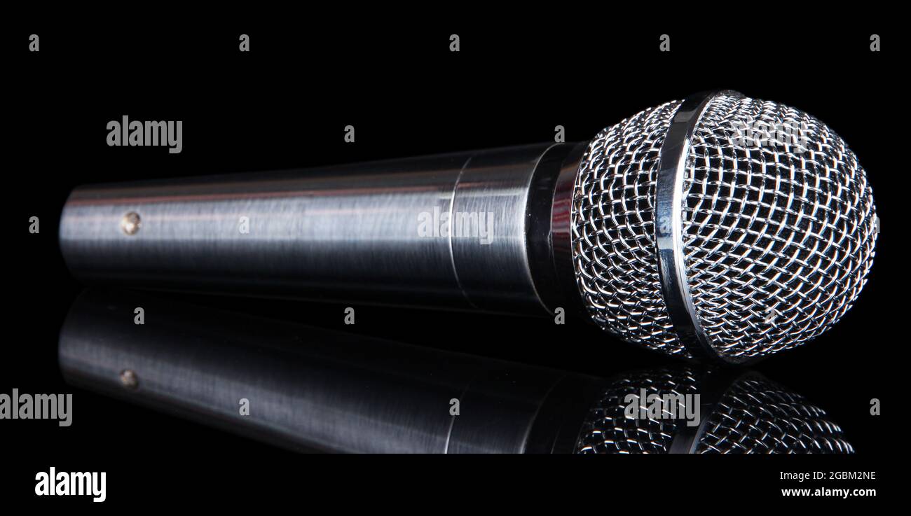 Silver microphone isolated on black Stock Photo - Alamy
