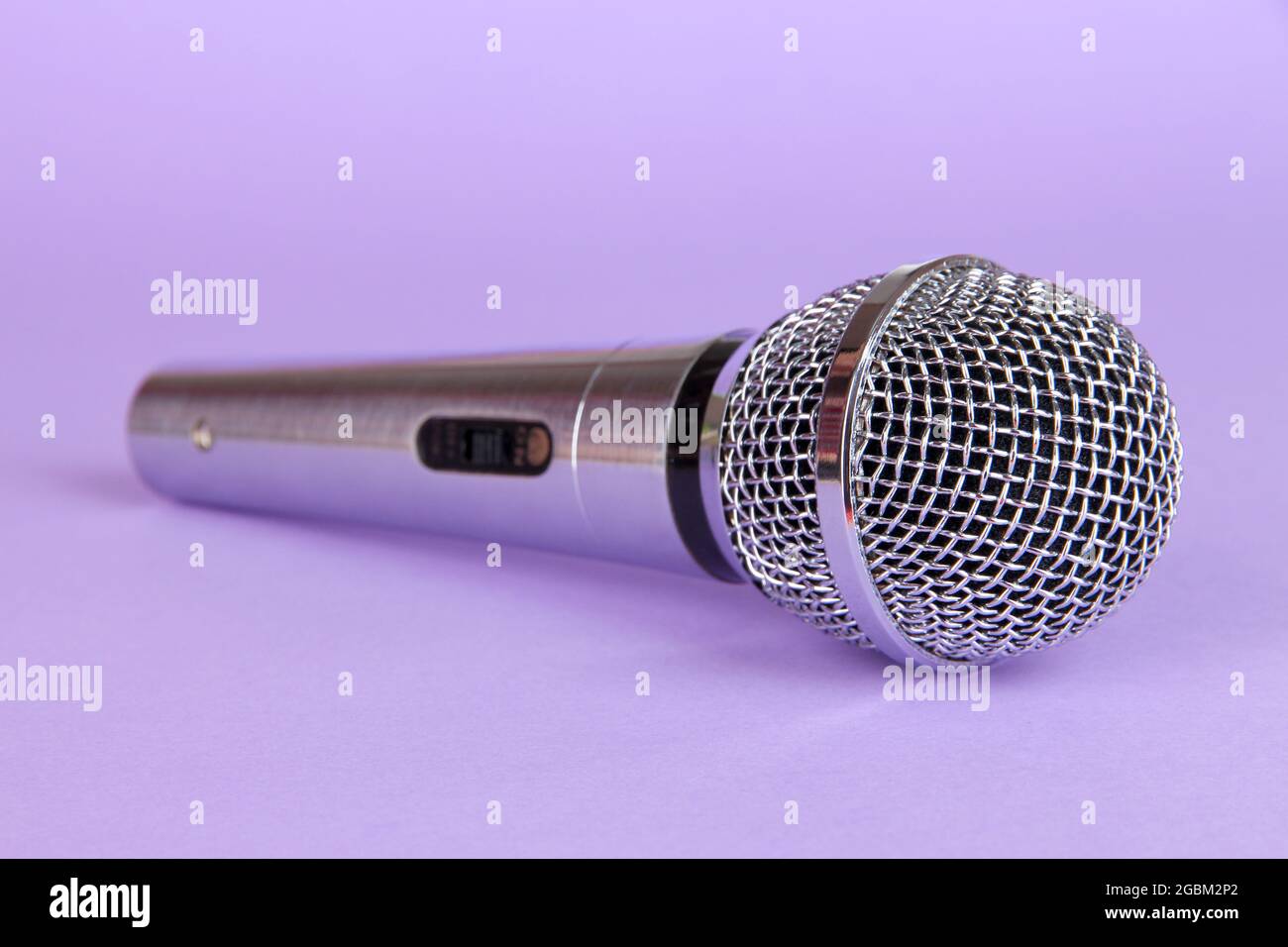 Silver microphone on purple background Stock Photo - Alamy