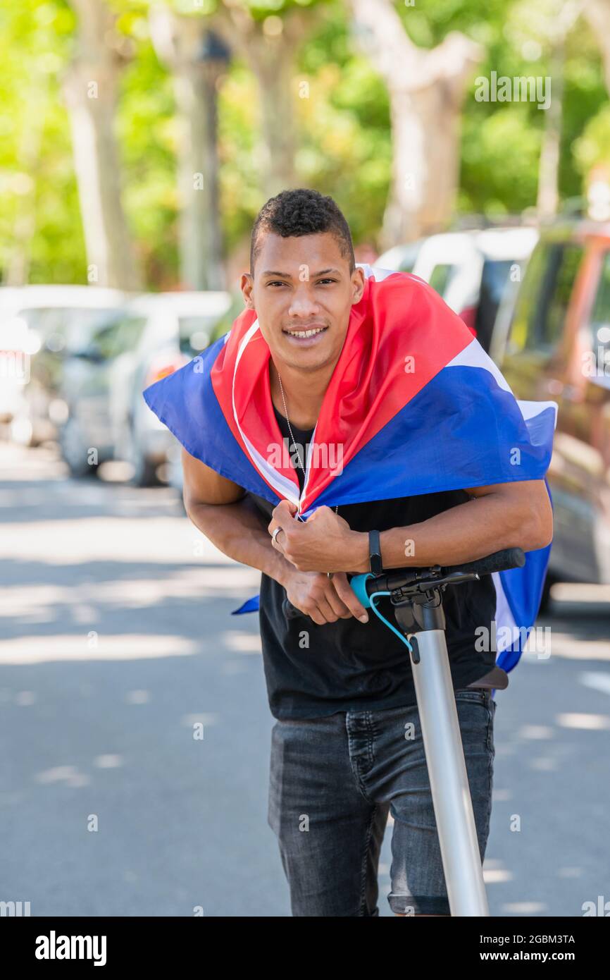 Close up of latino man wearing the cuban flag smiling at the camera ...